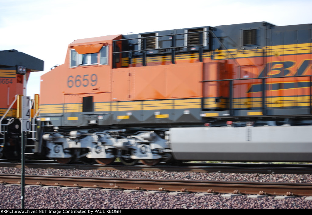 BNSF 6659 blurs as she passes me doing over 60 mph as she heads east towards the town of Daggett ...